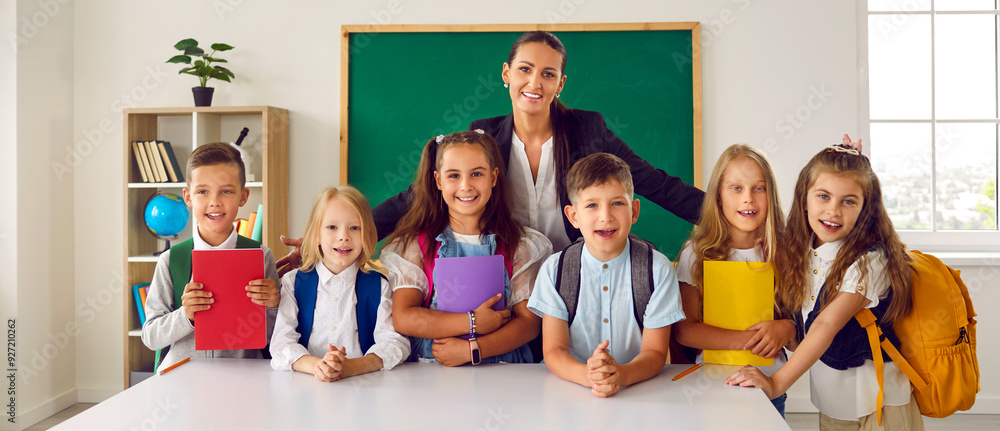 Portrait of female teacher and her little elementary school students on ...