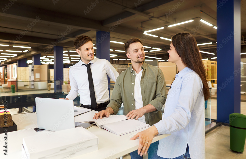 Salesman manager of construction market helping customers with choice ...