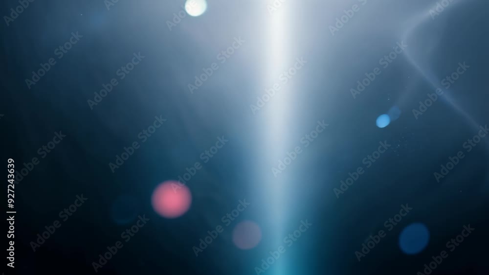 A brilliant beam of light shines from the top of a towering building ...