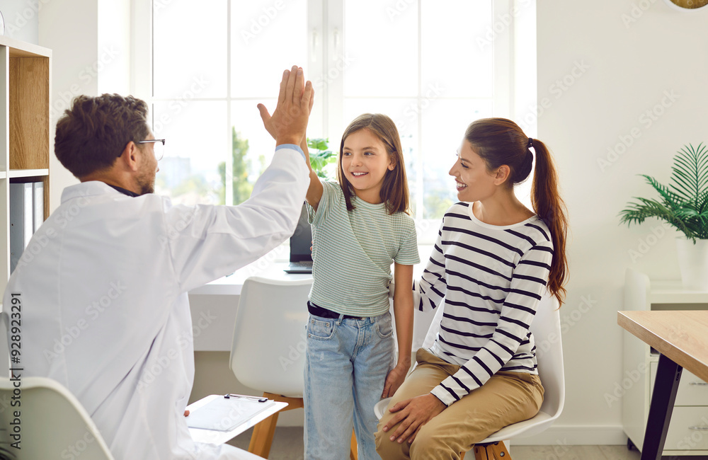 Friendly male pediatrician doctor giving high five to a little child ...