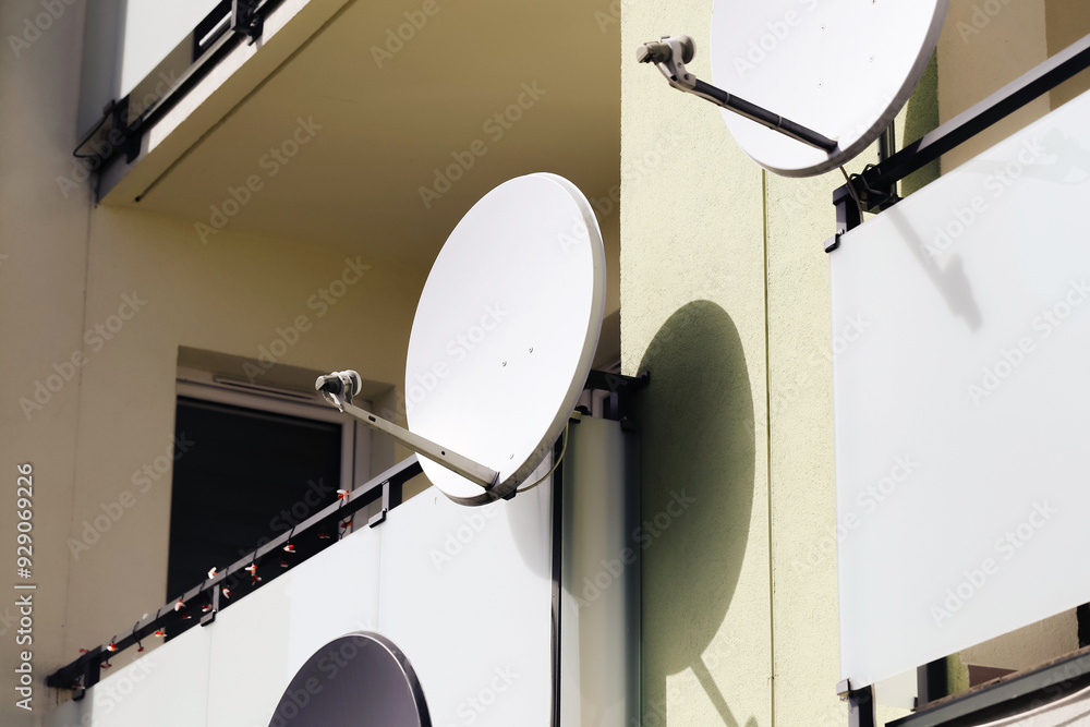 Apartment block with multiple balconies featuring satellite dishes ...