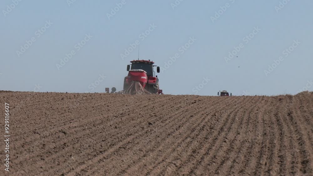 Tractor drilling seeding crops at farm. Agricultural activity. A ...