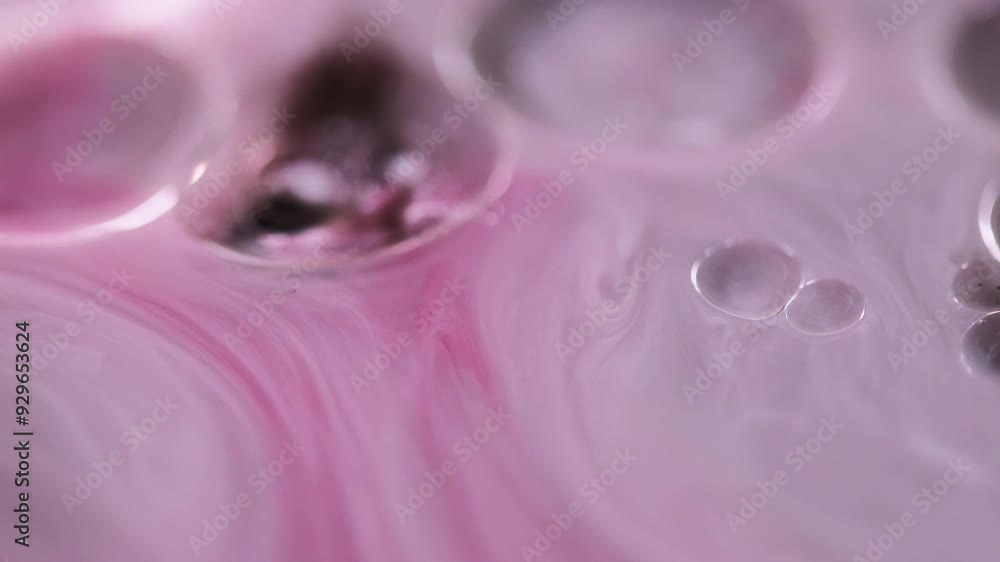 Oil bubbles. Fizzy liquid. Defocused pink black color transparent round ...