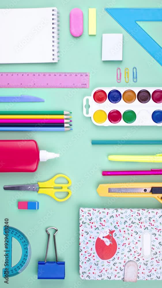 Flay lay top view layout of school supplies on the table. Pastel colors ...