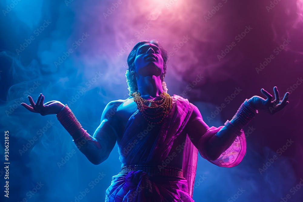 An Indian male performer in traditional clothing doing classical Indian ...