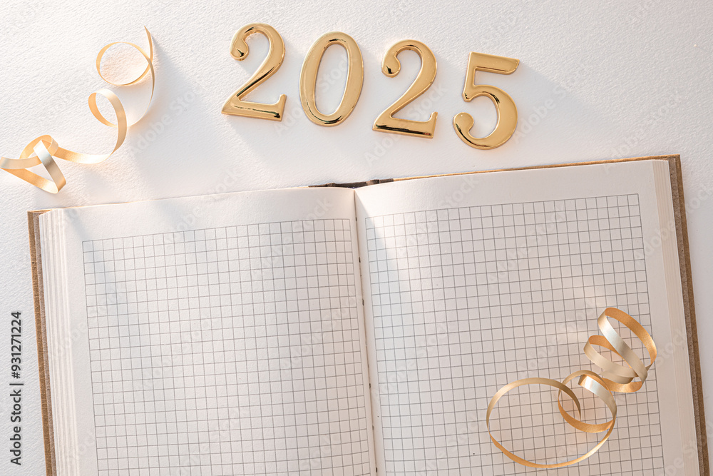 2025 planning with open notebook and golden decorative serpentine ...