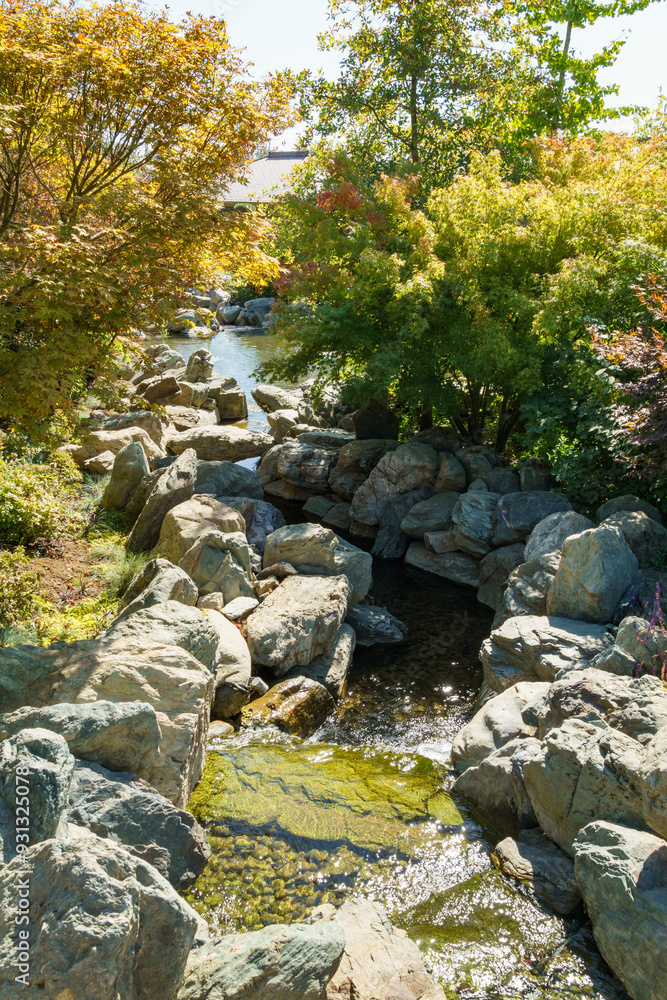 Triple waterfall splits into three streams in Japanese garden. Public ...