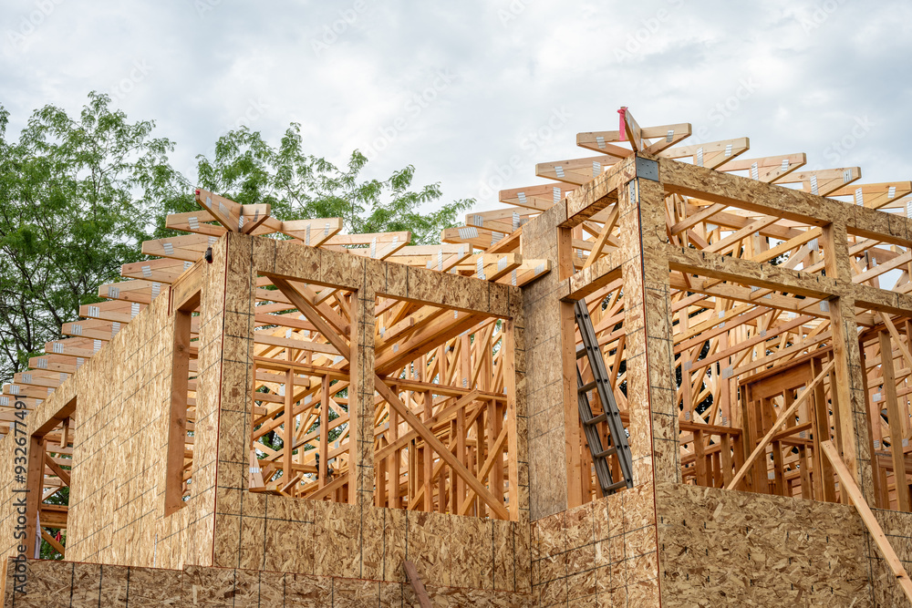 New residential home construction in framing stage, looking up at ...