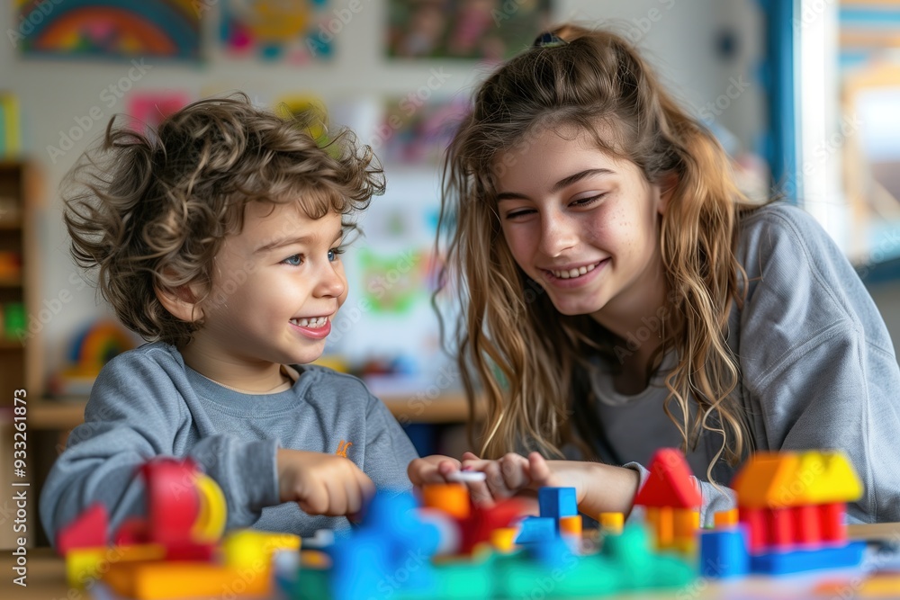 Portrait of a child with autism working with a therapist during a ...