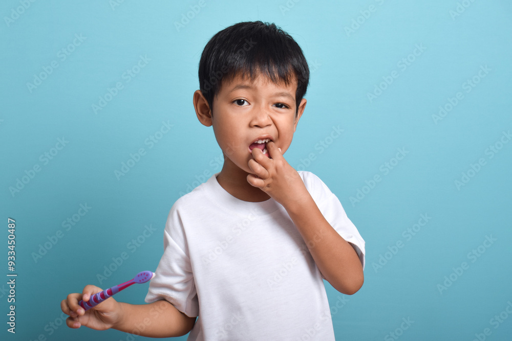 Little Asian boy suffering from toothache. emotional Asian boy who is ...
