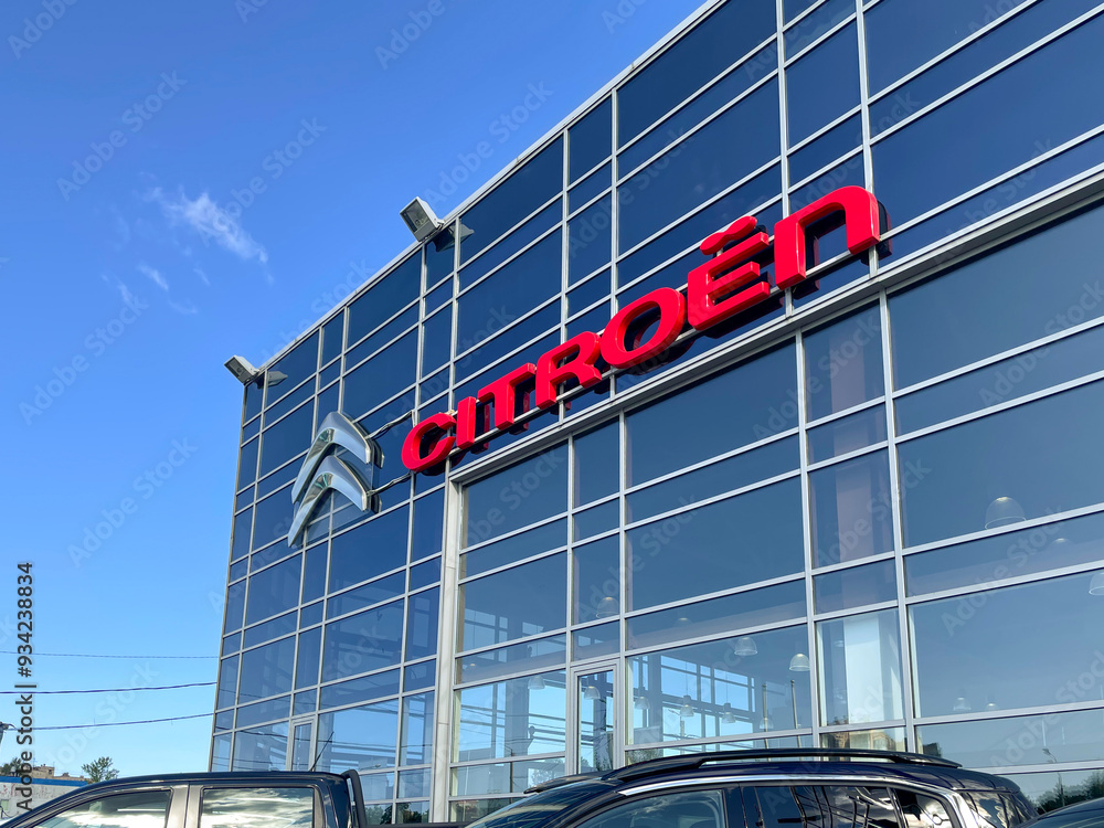 Citroen sign on glass facade of dealership building. Citroen logo and ...