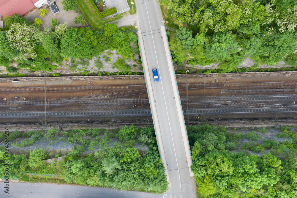Aerial view shot by a drone of a road bridge over the railroad tracks ...