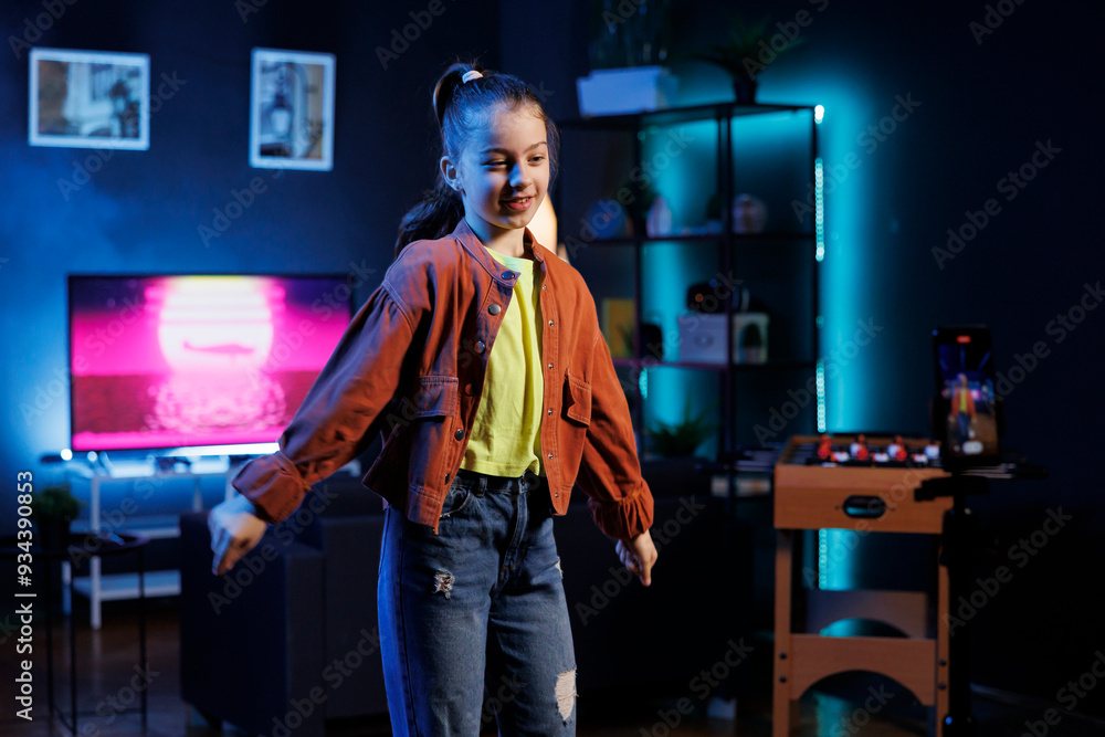 Kid in blue neon lit apartment doing viral dance for social media ...