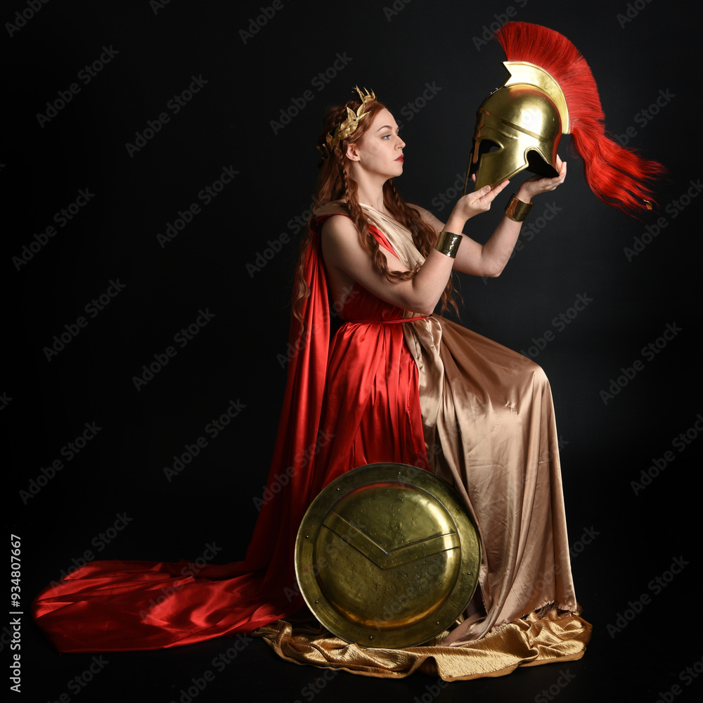 Full length portrait of beautiful female model wearing grecian red silk ...
