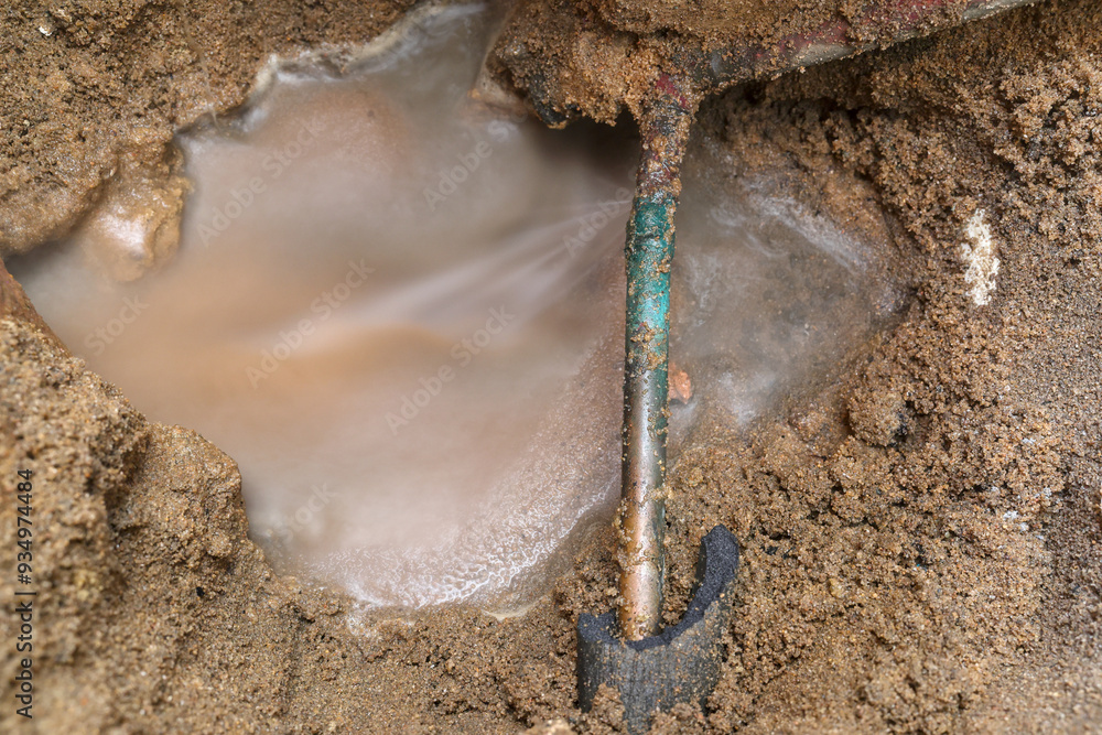Underground (subsurface) half inch copper water leakage. Leak detection, repair, DIY Stock Photo ...