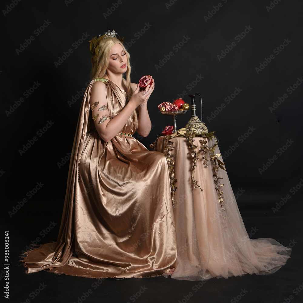 Full length portrait of beautiful female model wearing gold grecian ...