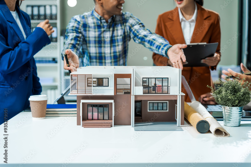 In an office room, architect-engineer team discusses modern house model ...