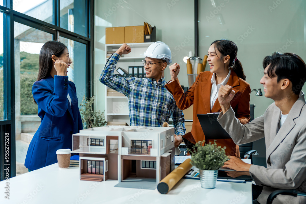 In an office room, architect-engineer team discusses modern house model ...
