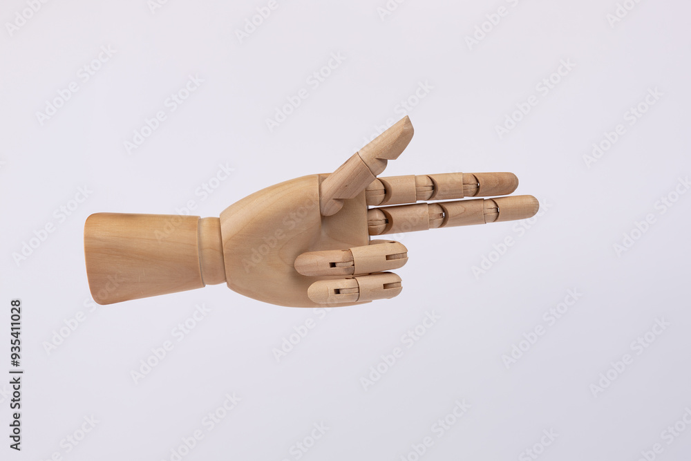 Wooden hand horizontally pointing with middle and index finger ...