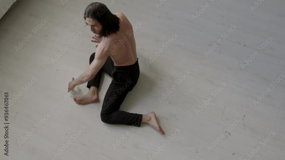 Top down shot of shirtless male dancer practicing contemporary moves on ...