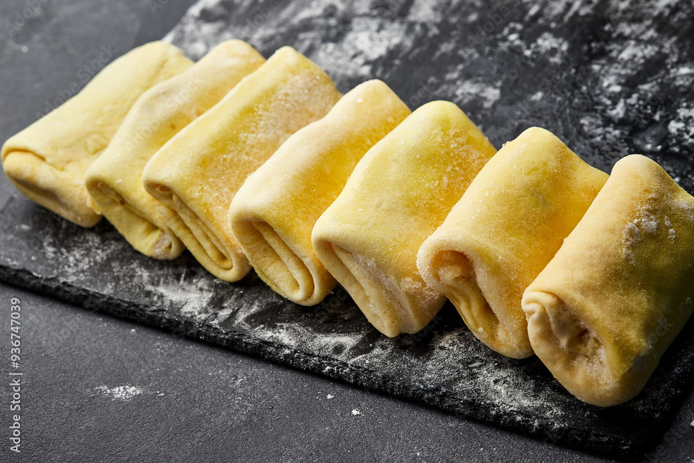 Freshly rolled stuffed crepes, ready for cooking, showcasing ...
