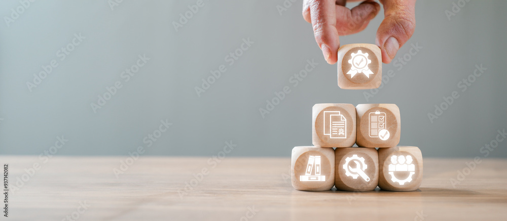 Wooden blocks with icons symbolizing ISO 9001 certification, quality ...