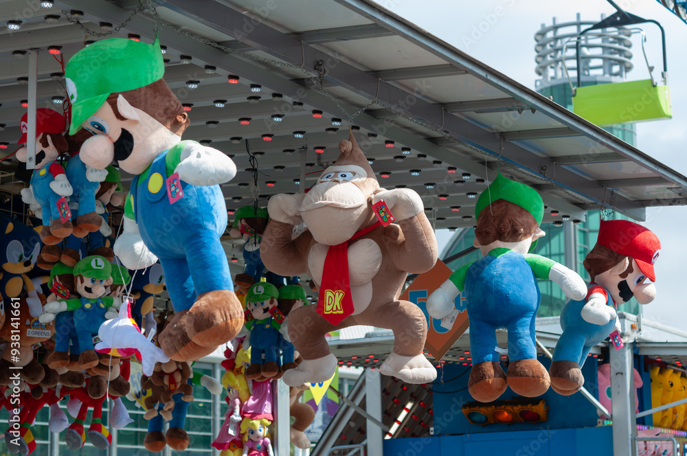 gaming booth with stuffed prizes (featuring characters from Super Mario ...