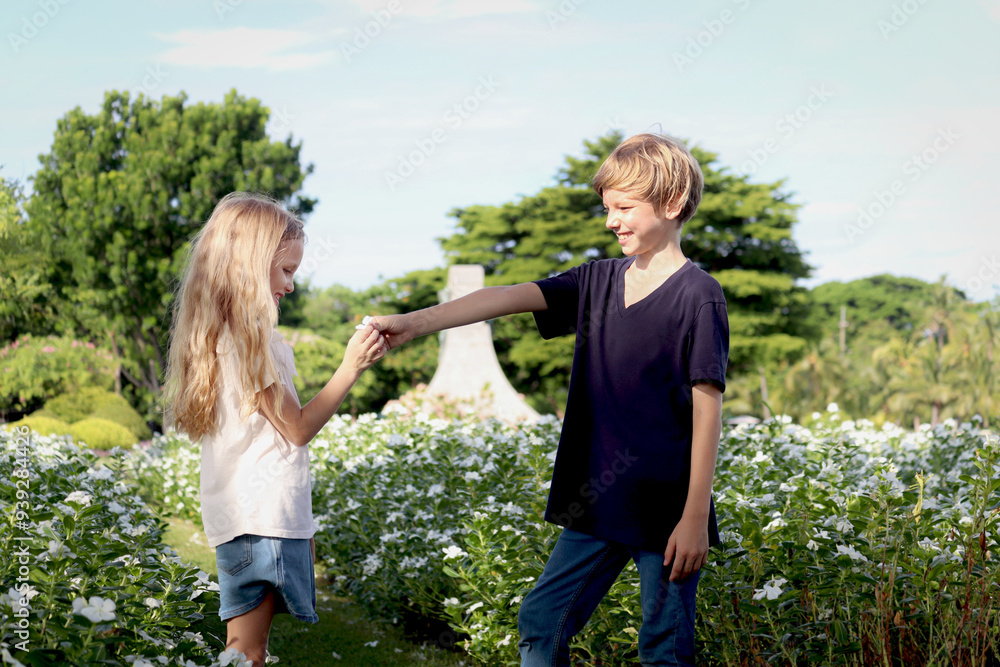 Happy family, brother gives flowers to his little sister at beautiful ...