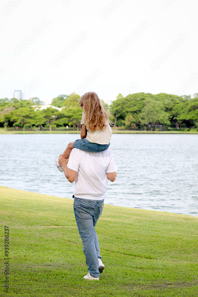 Back of father carrying cute daughter, joyful parent piggybacking his ...