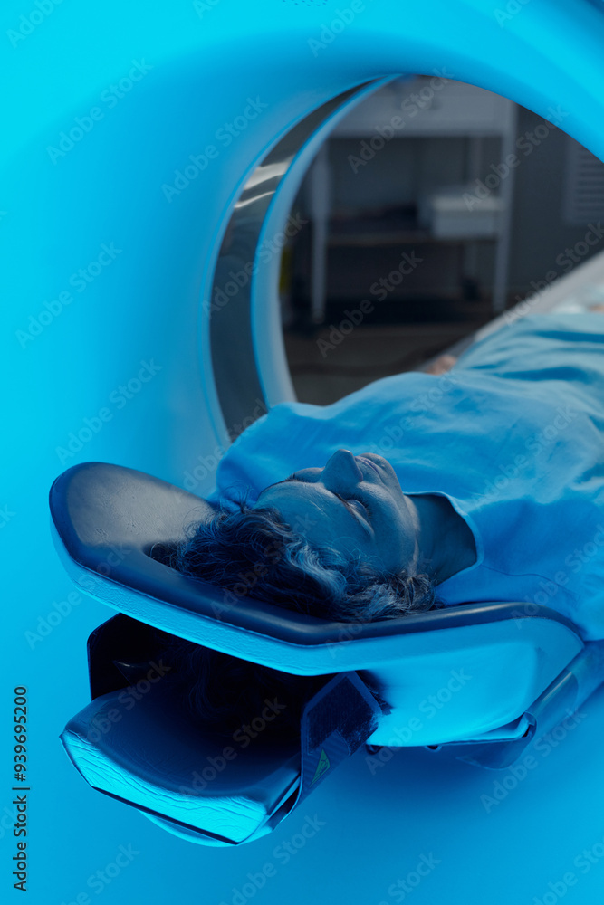 Patient lying under MRI machine in radiology room feeling calm with ...