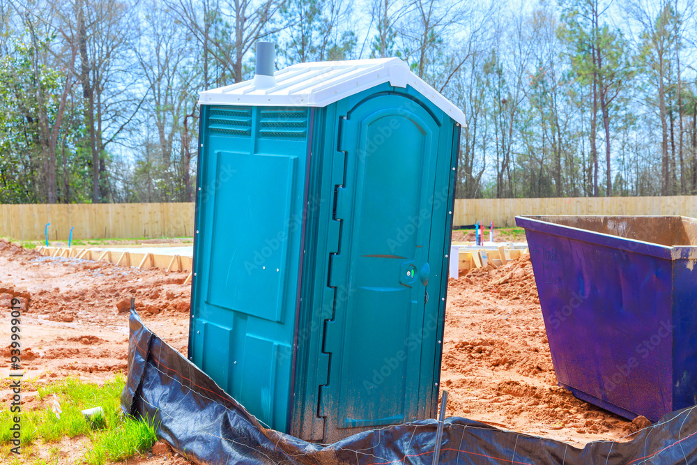 During construction of house, portable plastic bio toilet stalls are ...
