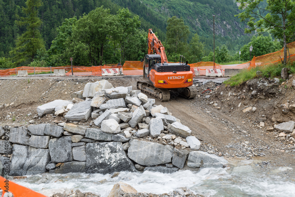 Hitachi excavator used to build a mountain creek embankment to avoid ...