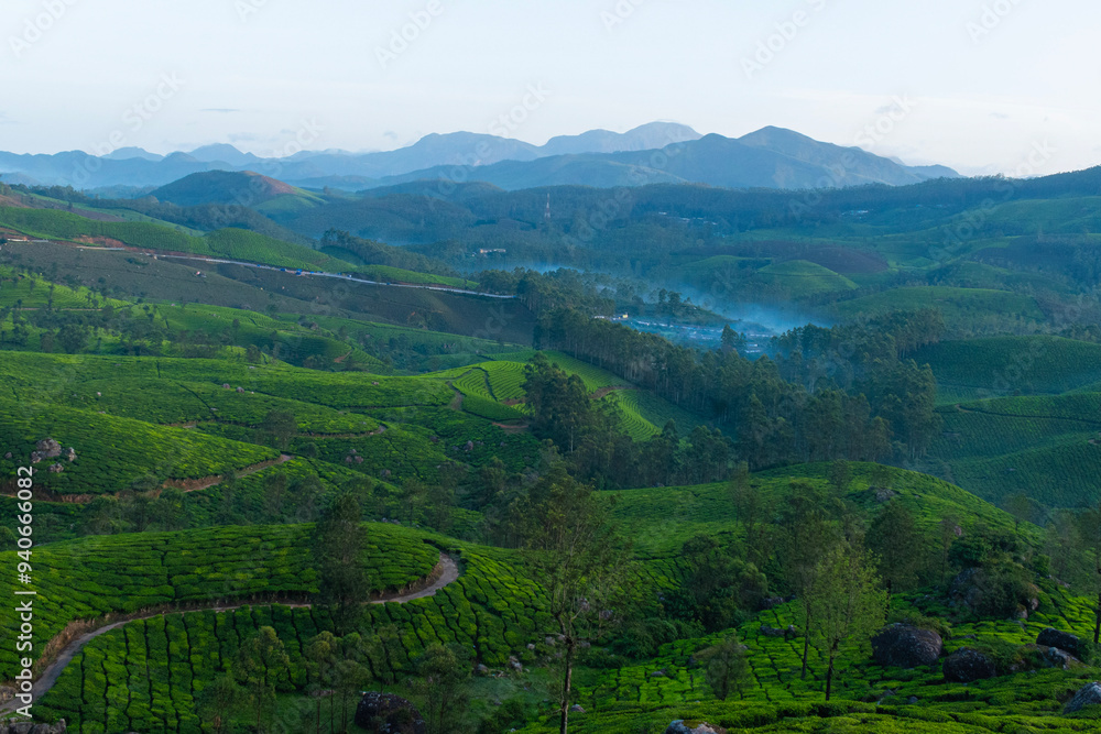 Mountain ranges covered in fog in Munnar which is one of the beautiful ...