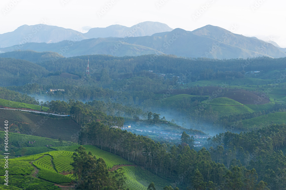 Mountain ranges covered in fog in Munnar which is one of the beautiful ...