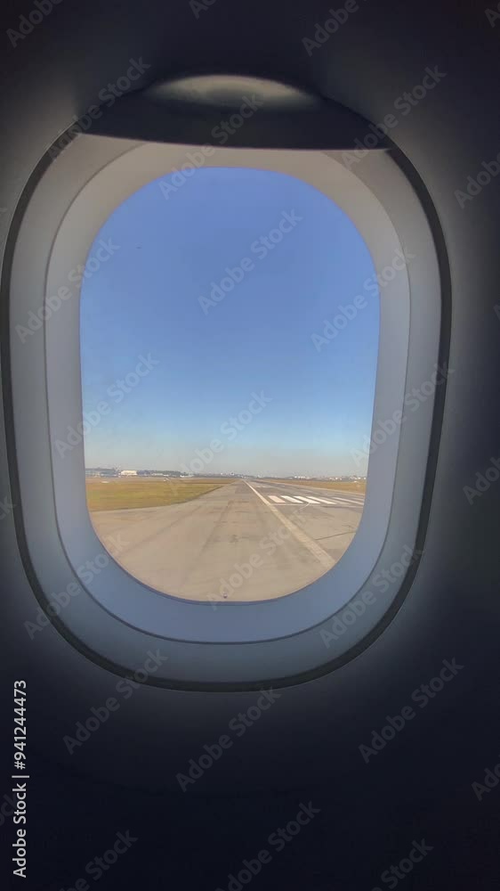 View of airport apron, runway, POV video from passenger porthole window ...