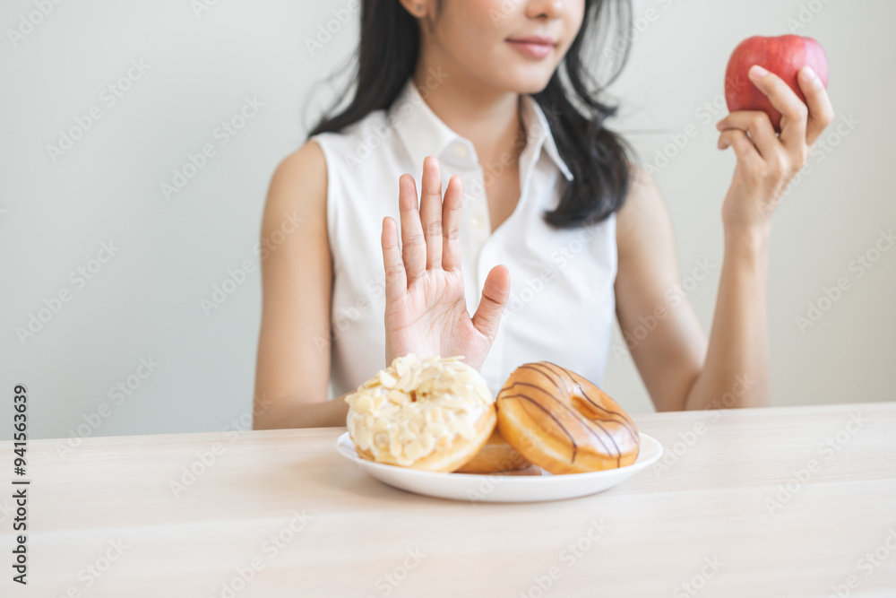 Diet asian young woman hand push out, refuse sugar donut, doughnut and sweet taste on plate and ...