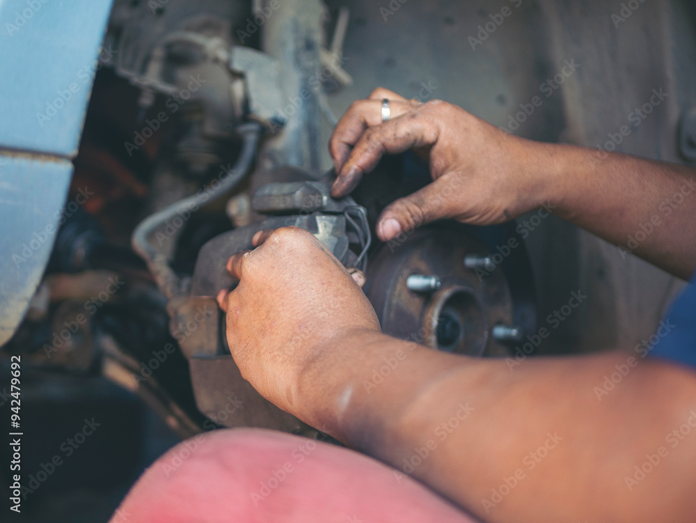 Close up Mechanic man hands repairing car auto repair shop uses jack ...