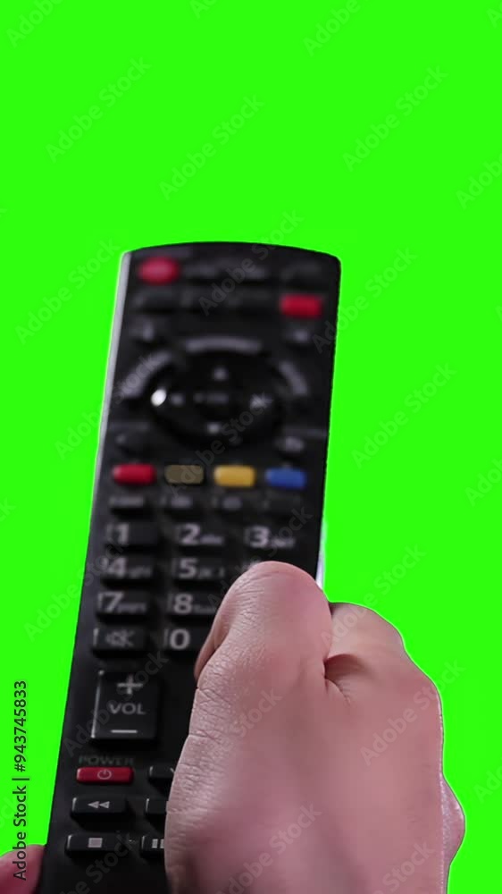 4K Vertical: Hand Holding TV Remote Against Green Chroma Key Background ...