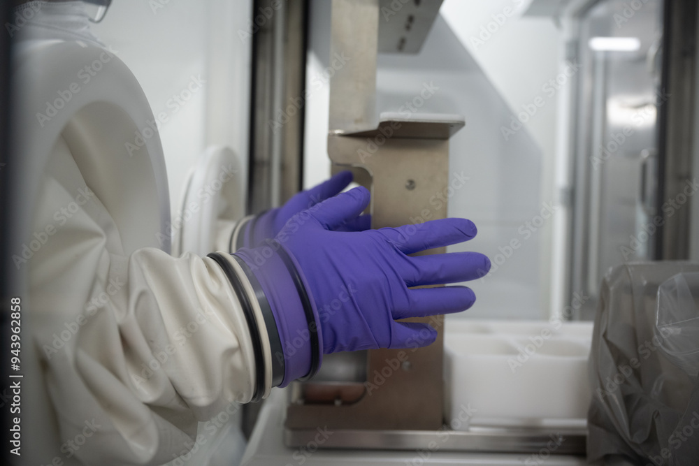 Close up scientist wearing blue gloves working with robot in the flume ...