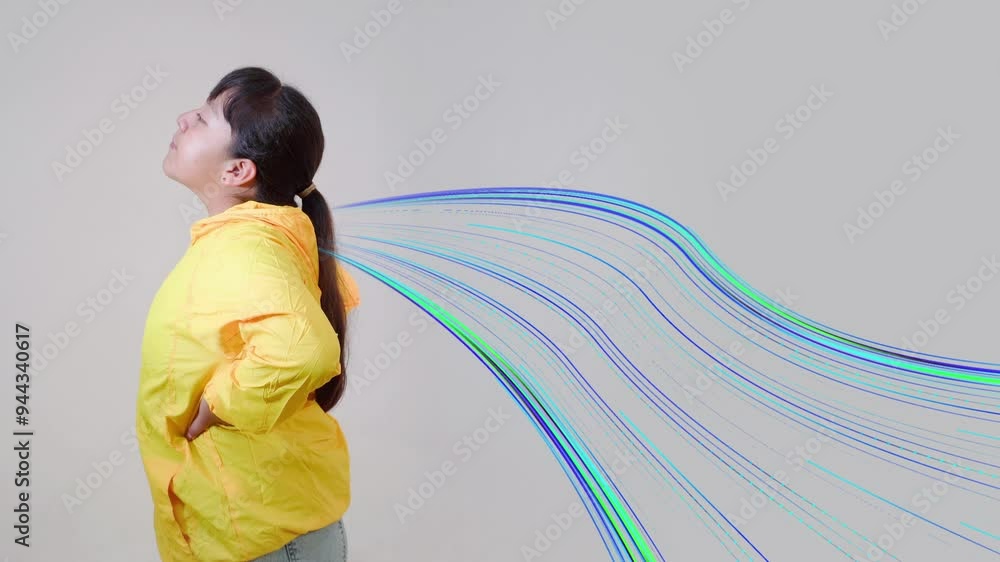 A girl wearing a yellow jacket and strikes a heroic pose. On a solid ...