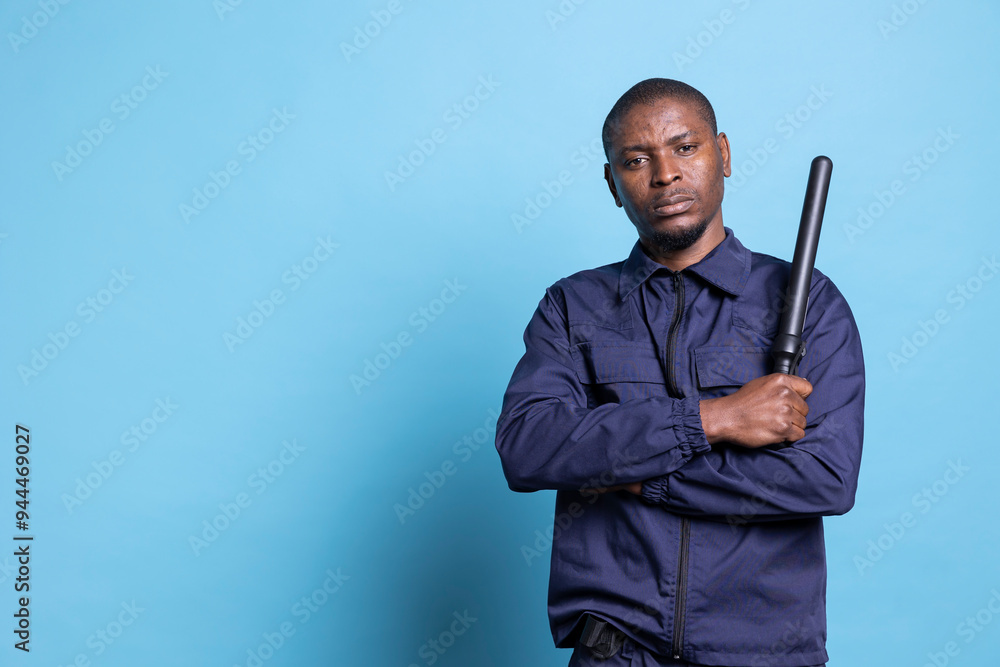 African american security officer poses proudly with his baton on ...
