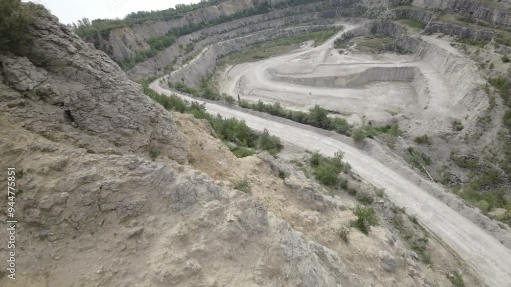 This 4K aerial video showcases a limestone quarry from a birds eye view ...