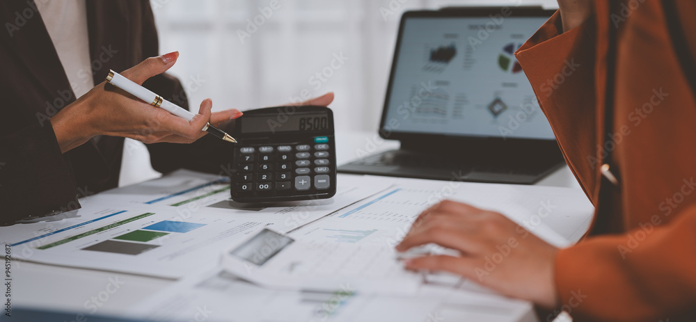 Team work process Business team use calculator to calculate figures ...