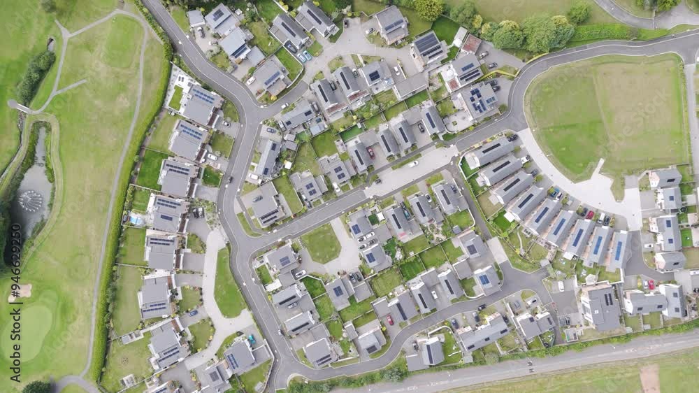 Rotating aerial view of a new housing estate, highlighting the solar ...