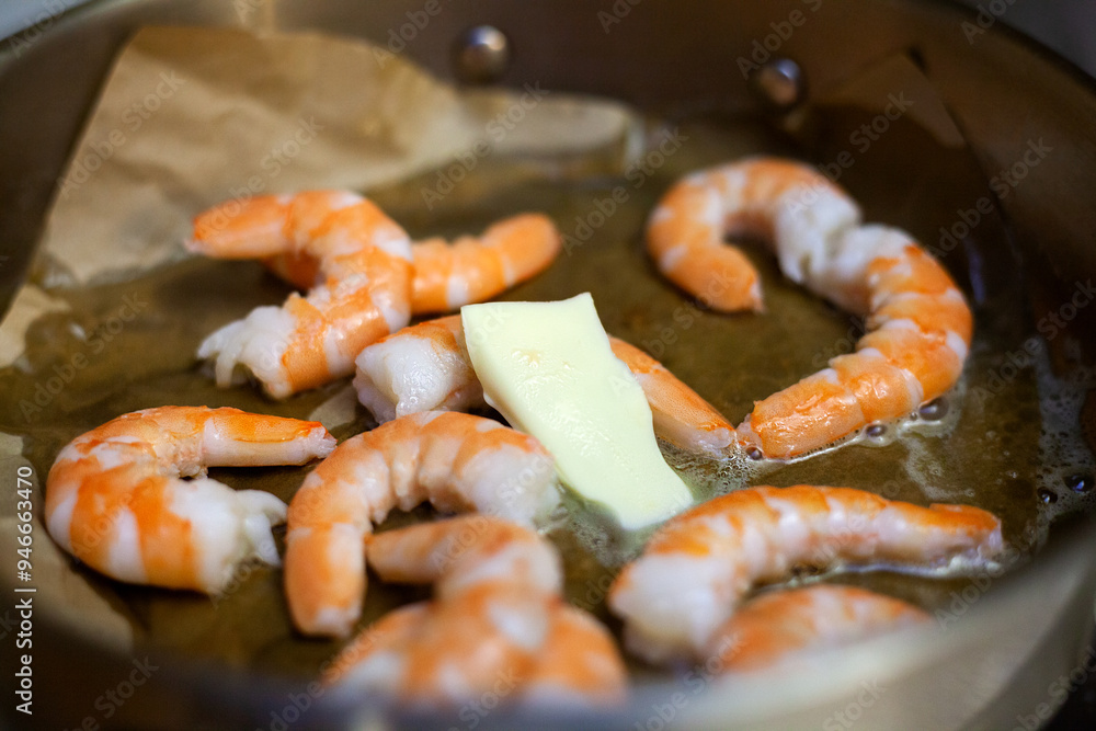shrimp in a frying pan with butter, step of cooking salad with shrimp ...