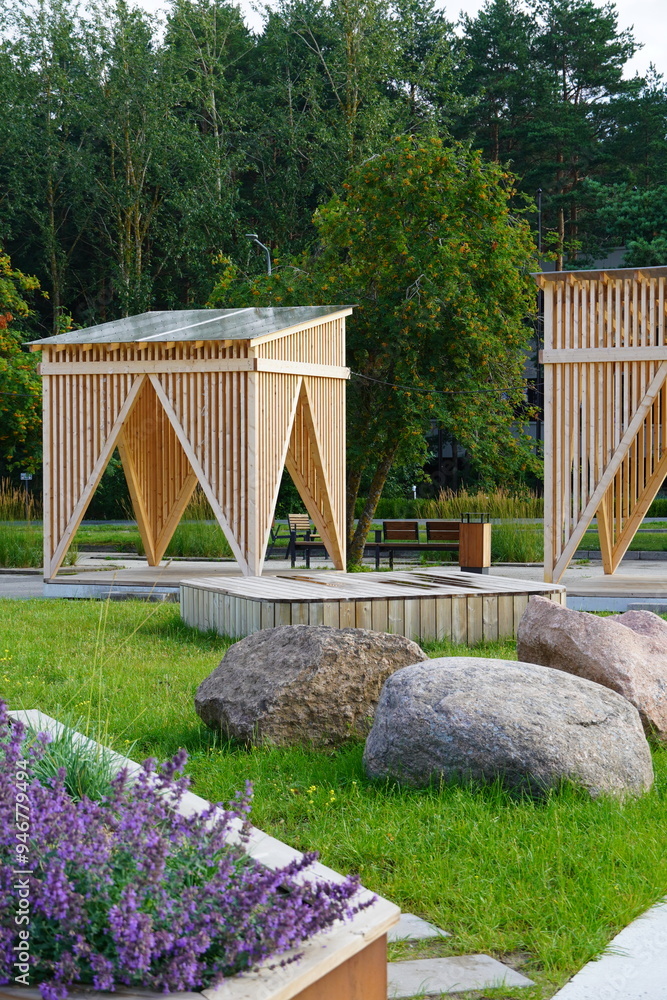 Modern wooden arbors, gazebos. Landscape design with green grass and ...