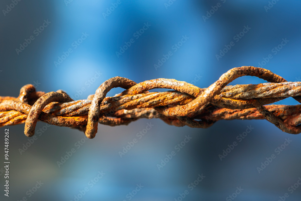 Rusty twisted wire on tonned backgraund, represents separation, danger ...