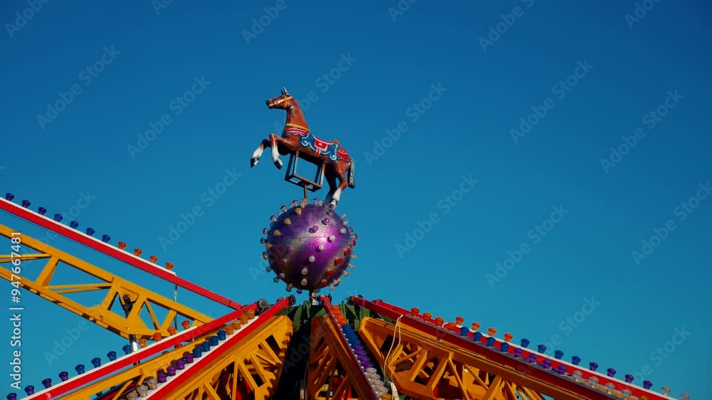 A vibrant amusement ride adorned with glowing lights against the night ...