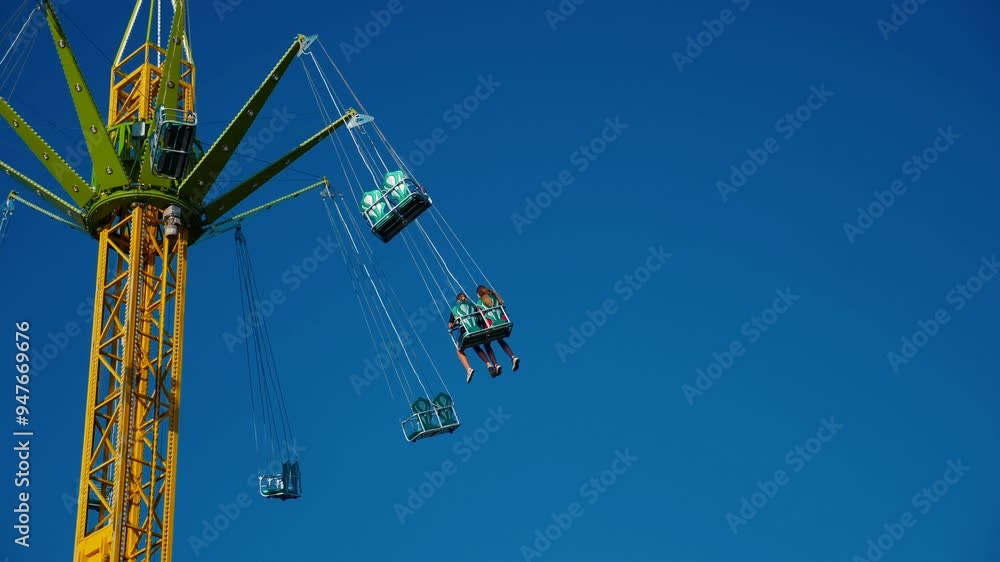 A vibrant amusement ride adorned with glowing lights against the night ...