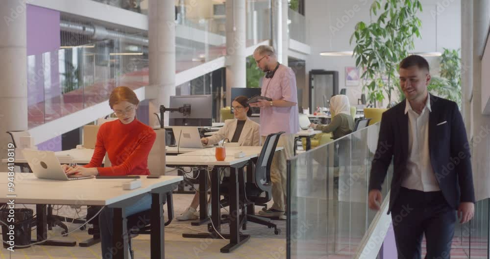 A director arrives at a large, modern office, where he joins his ...